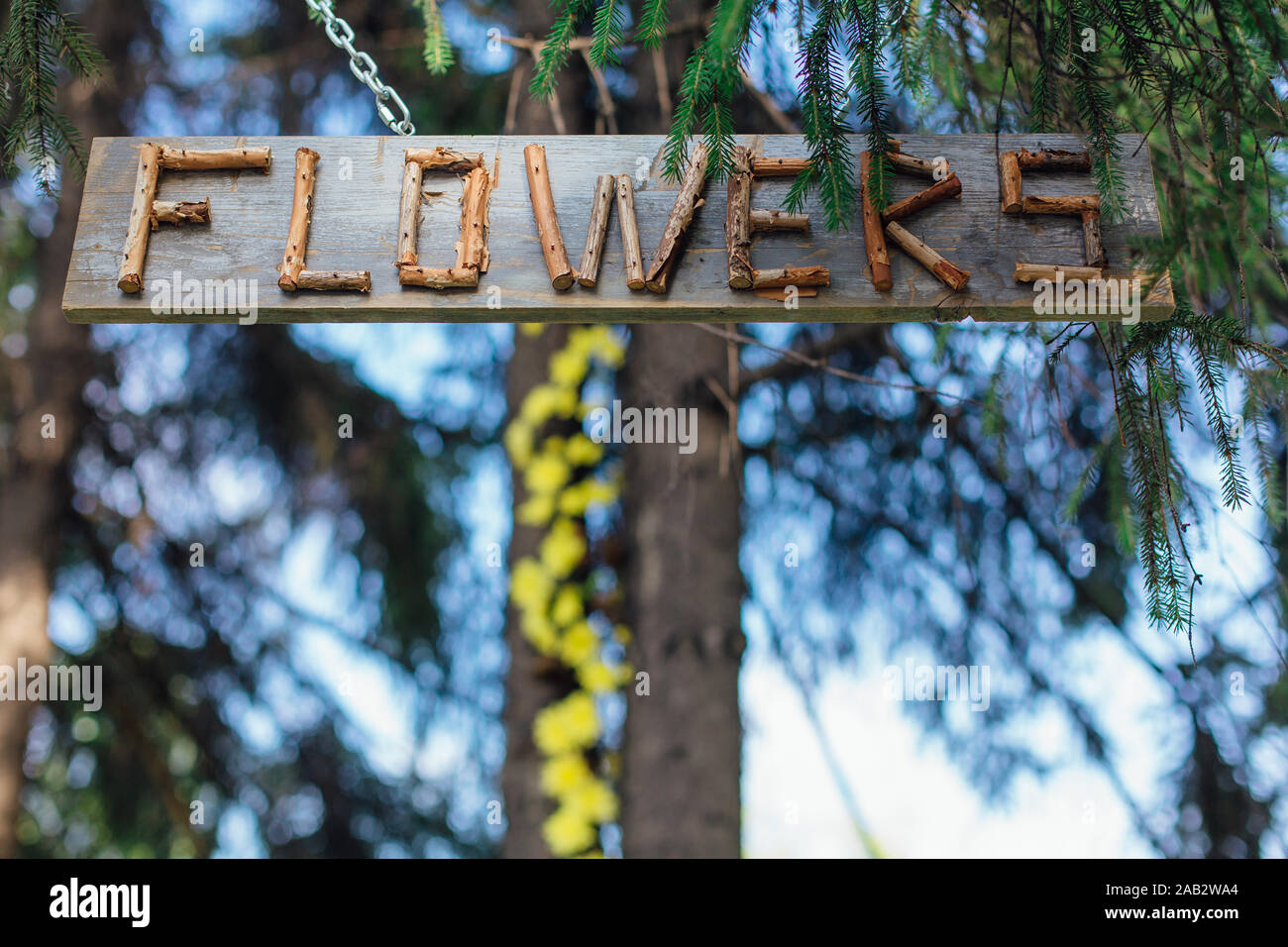 Word FLOWERS made of dry branches on the wooden sign Stock Photo - Alamy