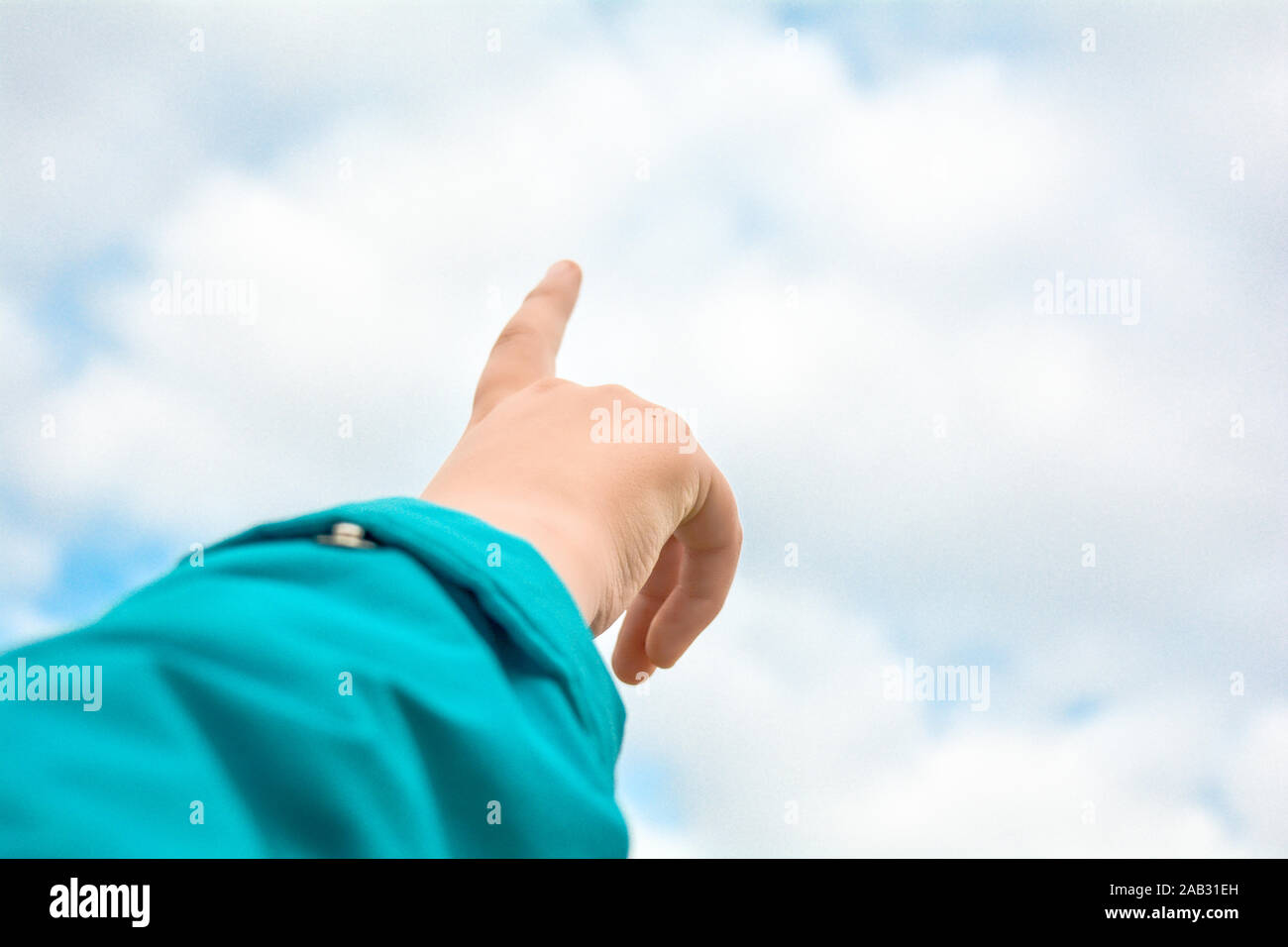 Close up of hand of child with exposed index finger in blue sleeve ...