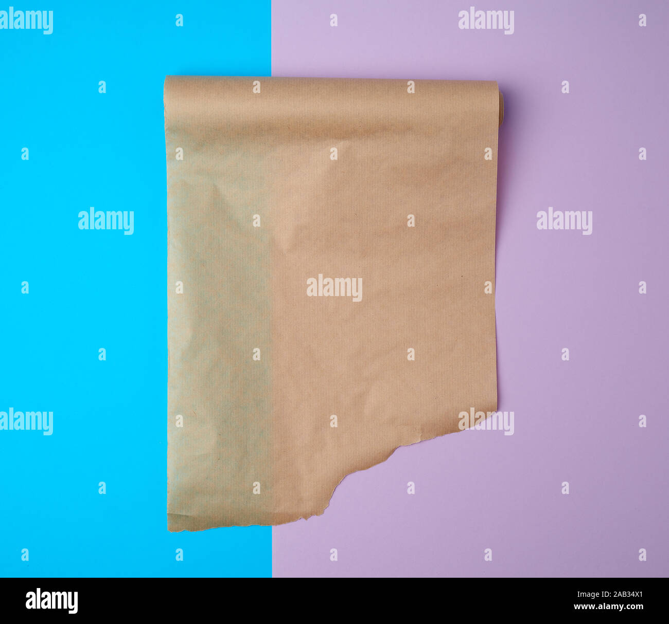 unwrapped a roll of brown parchment paper on a colored background ...