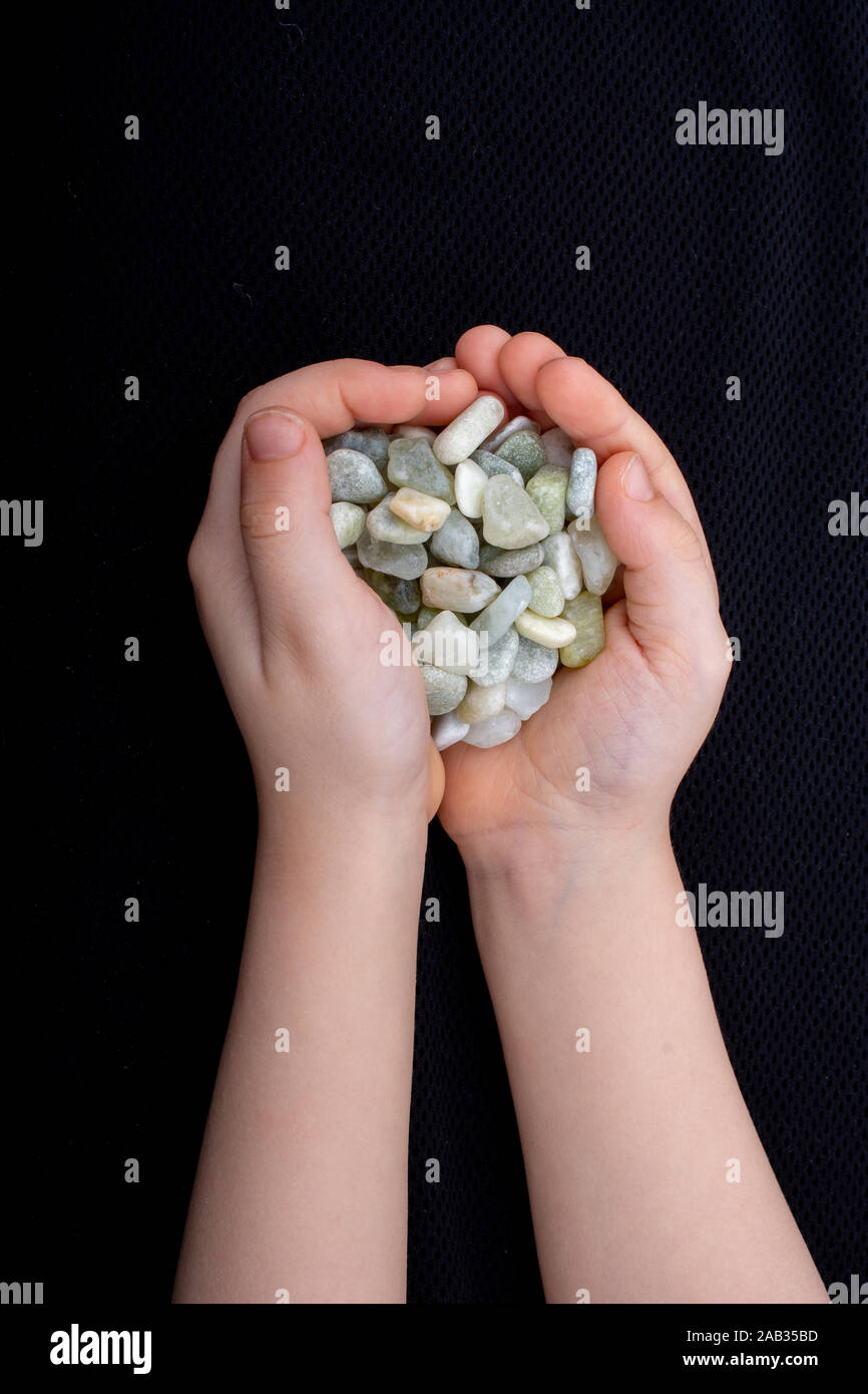 Handful of clean pebbles, gravels in hands Stock Photo - Alamy