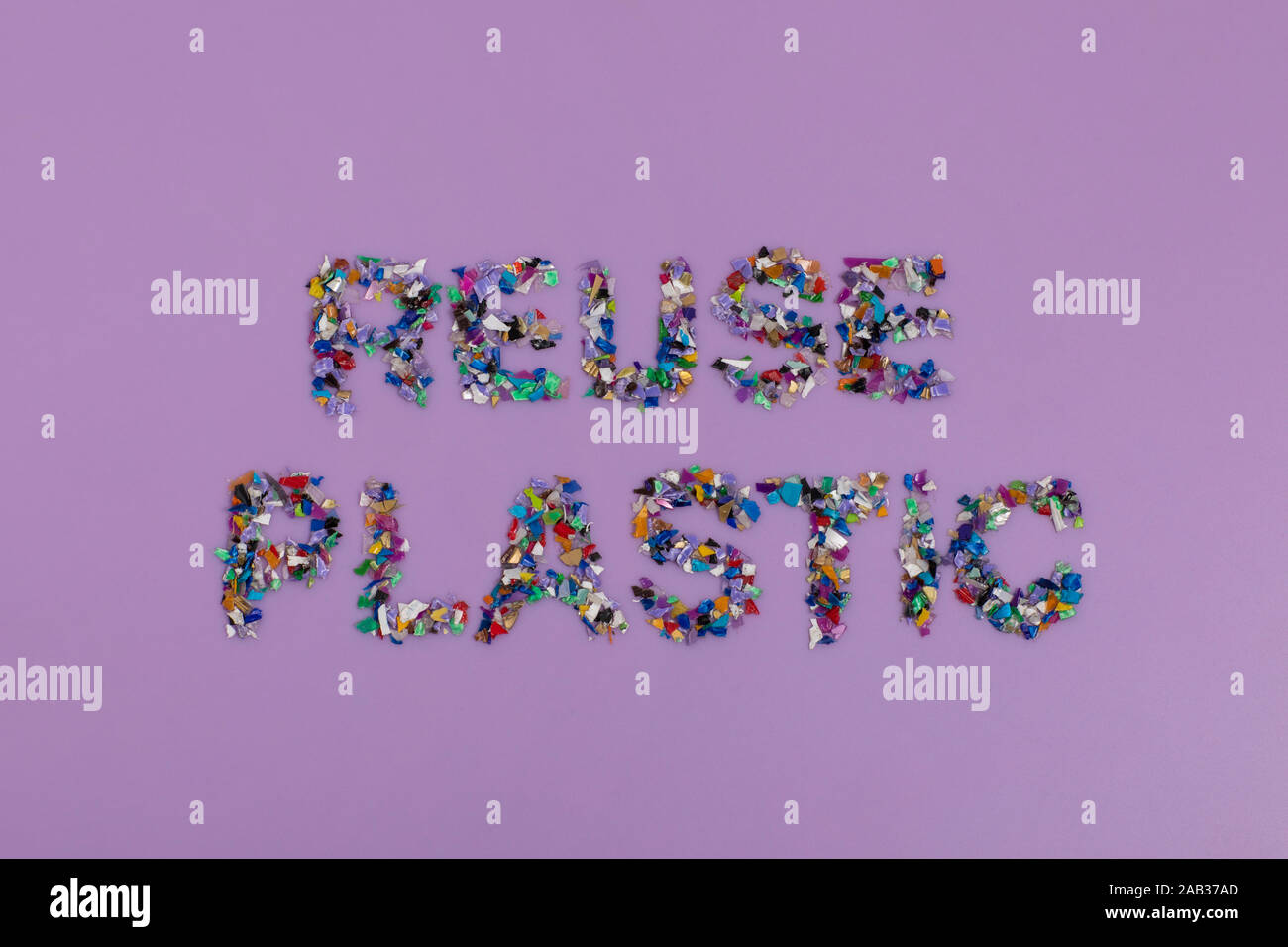 Reuse plastic text consisting of small recycled plastic pellets ...