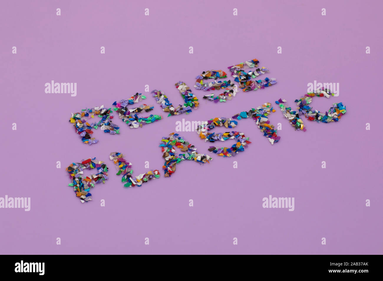 Reuse plastic text consisting of small recycled plastic pellets ...