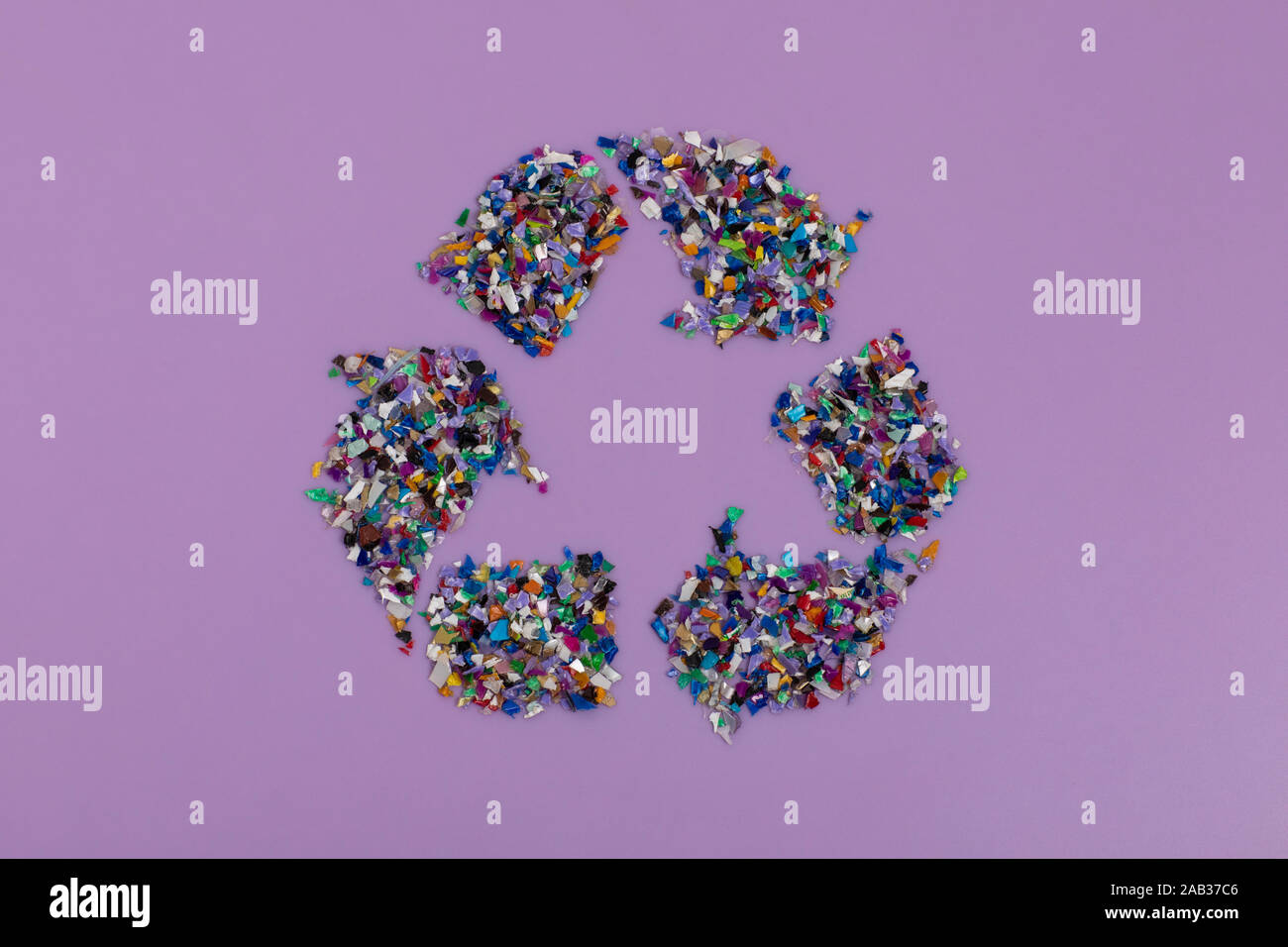 Recycle symbol consisting of small plastic pellets collected from the ...