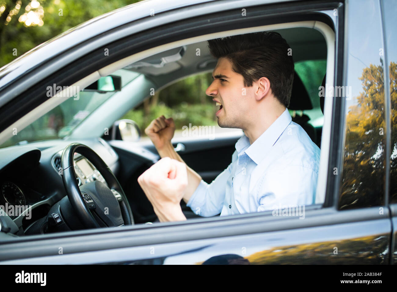 An irritated man driving a vehicle is expressing his road rage Stock ...
