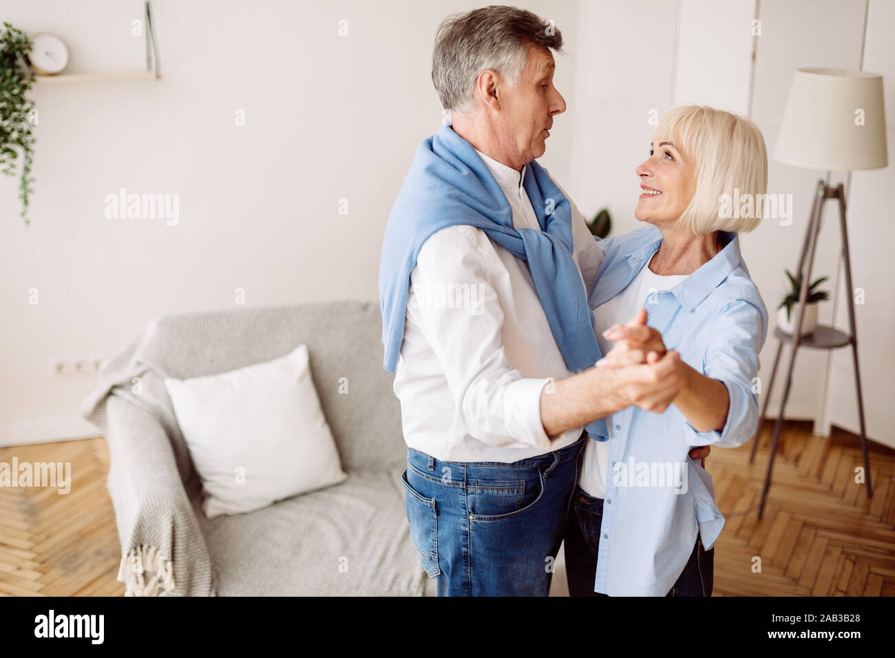 Happy retirement moments. Senior couple dancing at home Stock Photo - Alamy