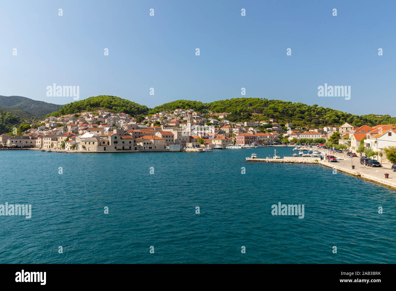 Pucisca town at Brac in Croatia, view from the sea on a sunny day in ...