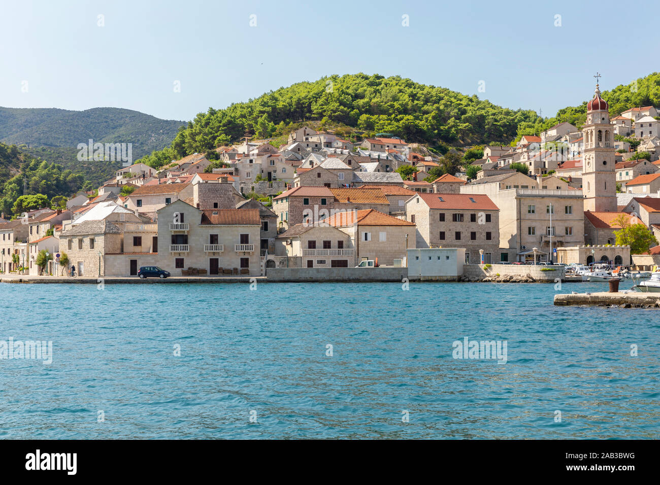 Pucisca town at Brac in Croatia, view from the sea on a sunny day in ...