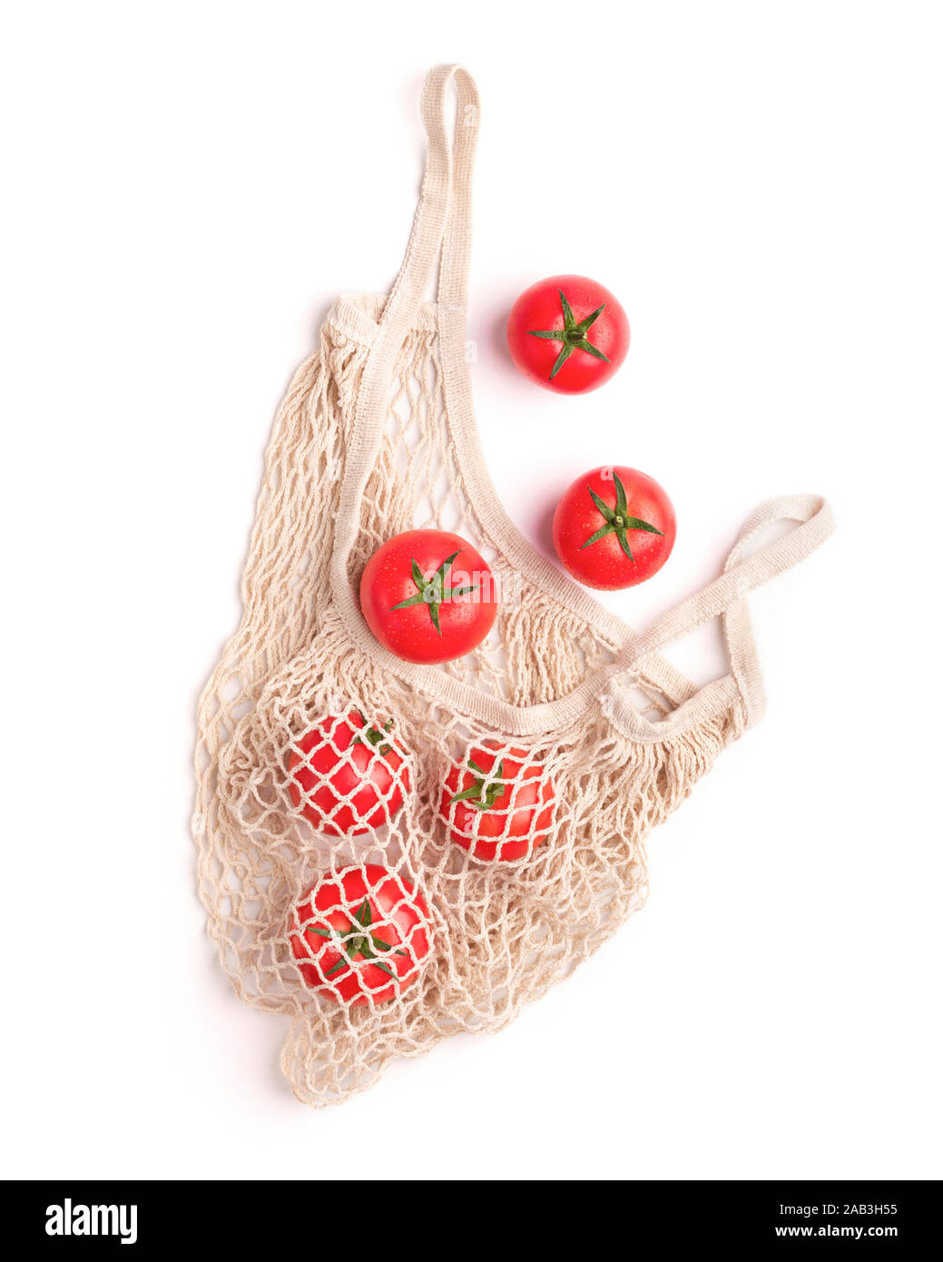 Clean and eco tomatoes in reusable net bag on white Stock Photo - Alamy