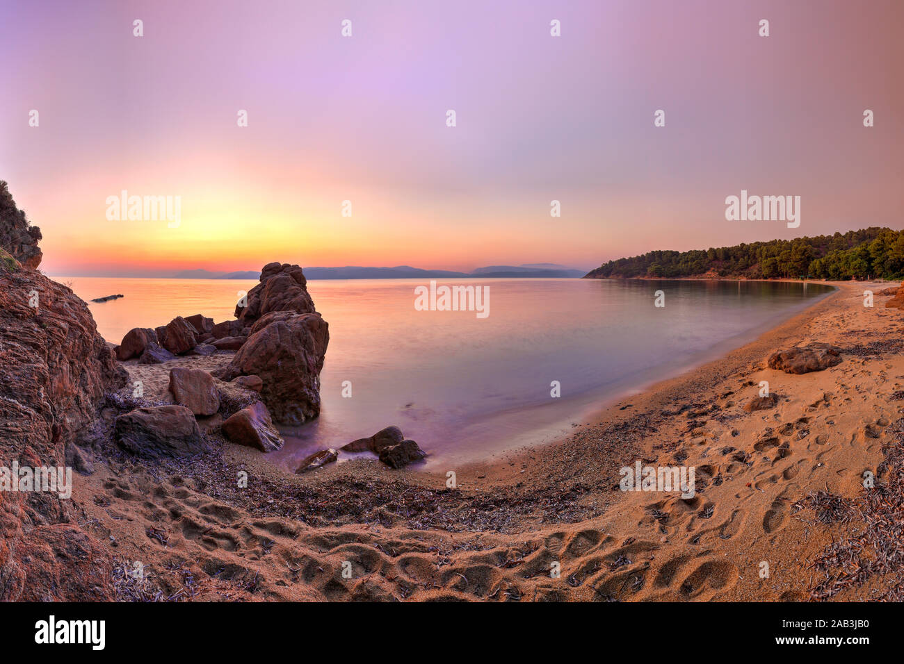 The sunset at the beach Agia Eleni of Skiathos island, Greece Stock ...