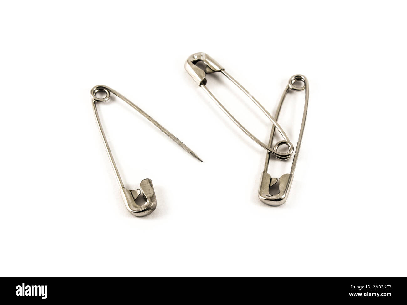 Safety pins isolated on white Stock Photo - Alamy
