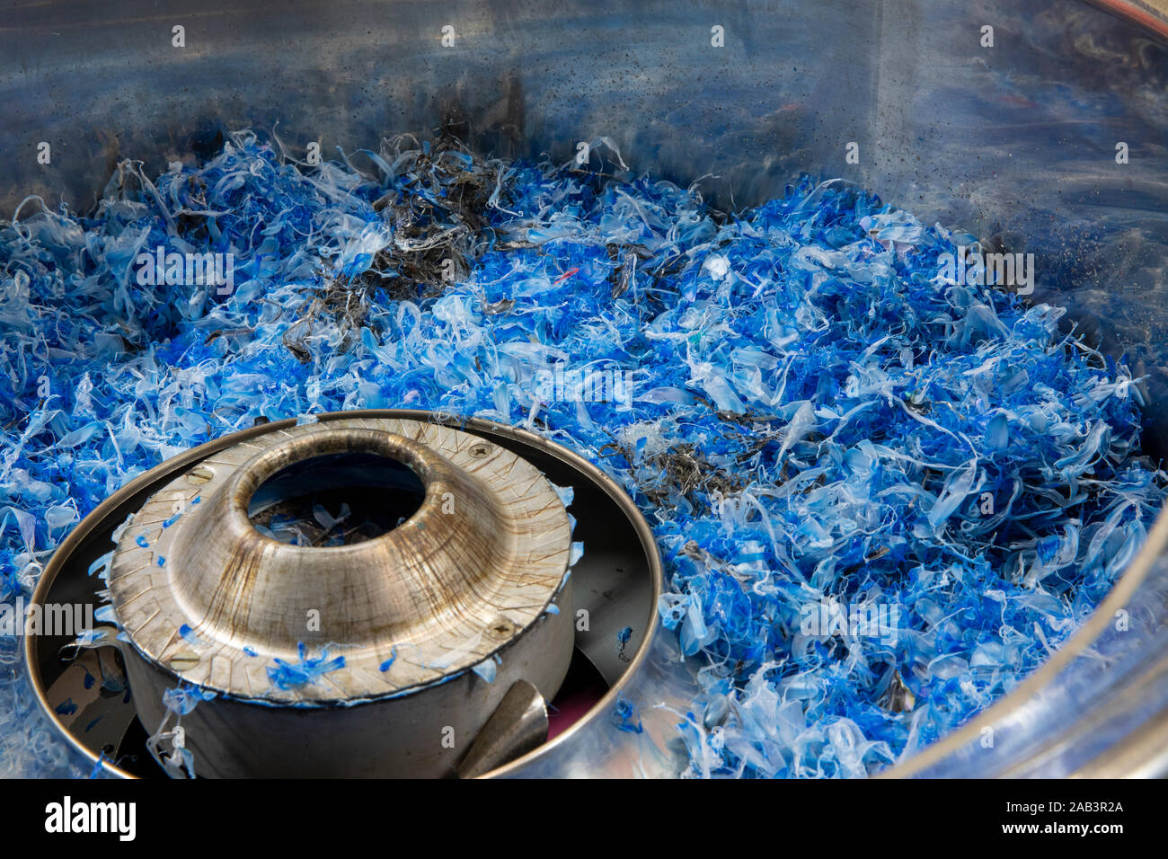 Blue plastic recycled parts material made of blue colored bottle caps ...