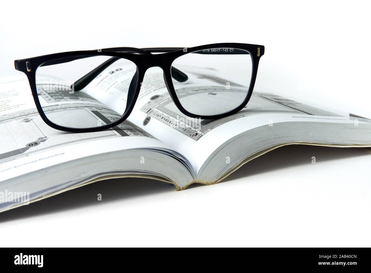 Eyeglasses on book isolated white background - image Stock Photo - Alamy