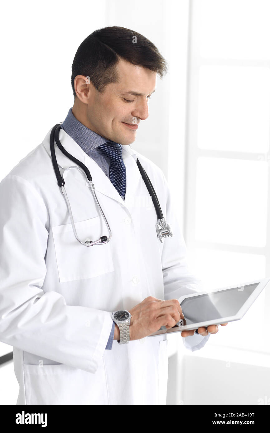Doctor man using tablet computer for network research or virtual ...