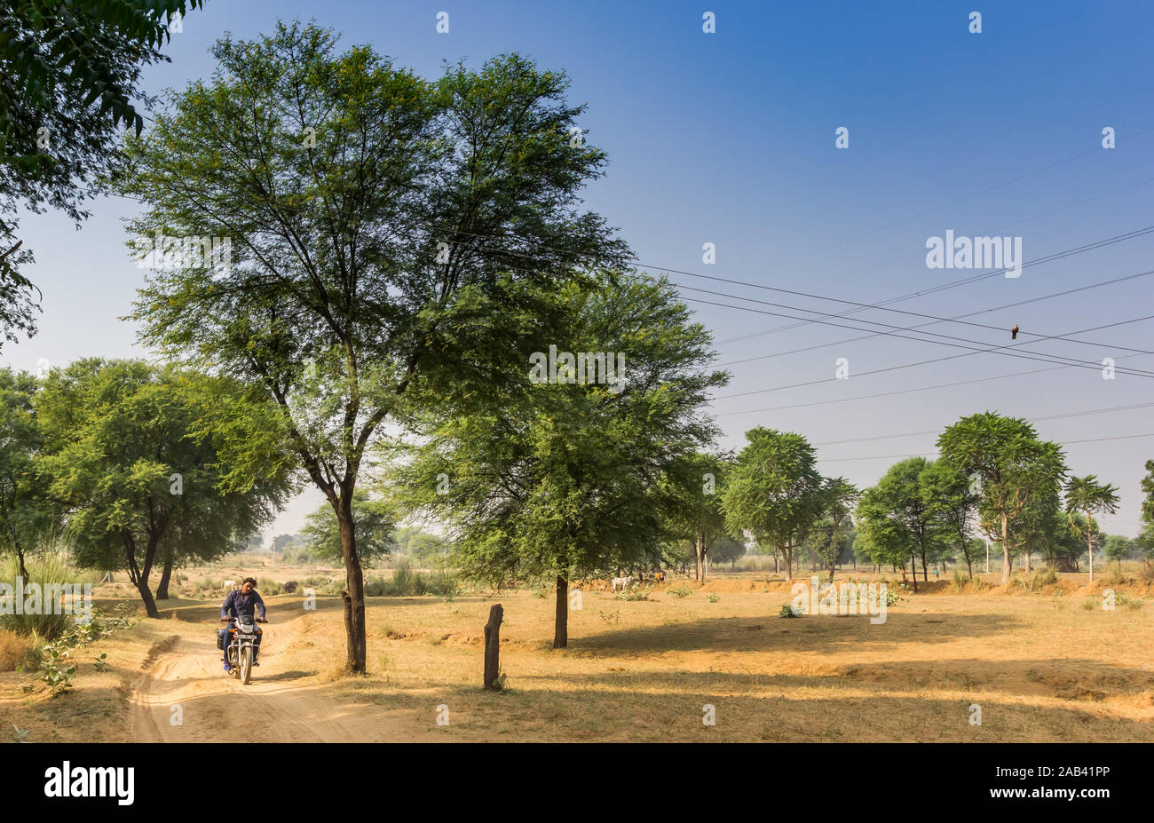 Motorcycle on a dirt road in rural Rajasthan, India Stock Photo - Alamy