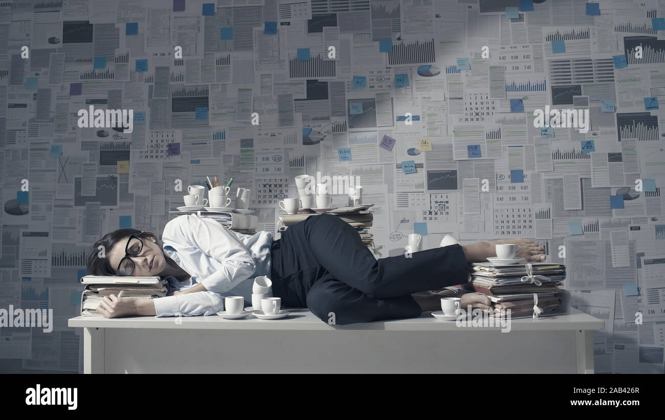 Exhausted business woman sleeping in the office, she is lying down on ...