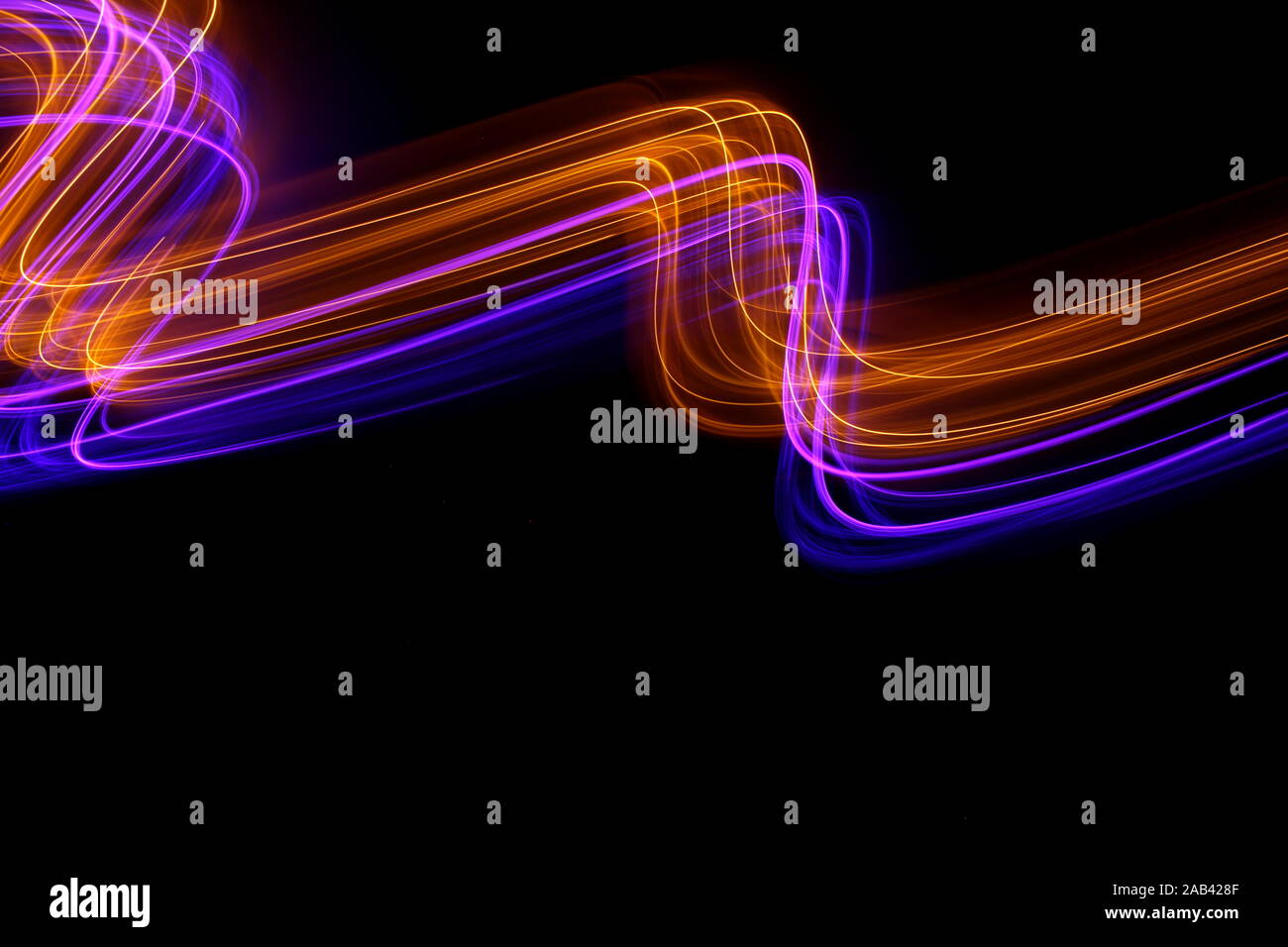 Long exposure photograph of neon colour in an abstract swirl, parallel ...