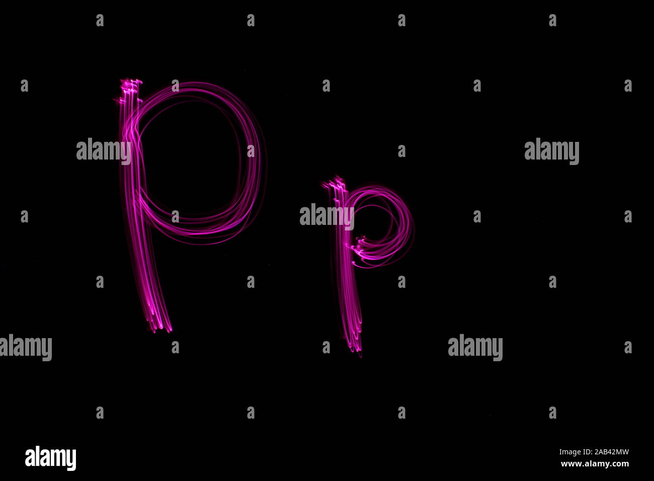 Long exposure photograph of the letter p in pink neon color, in upper ...
