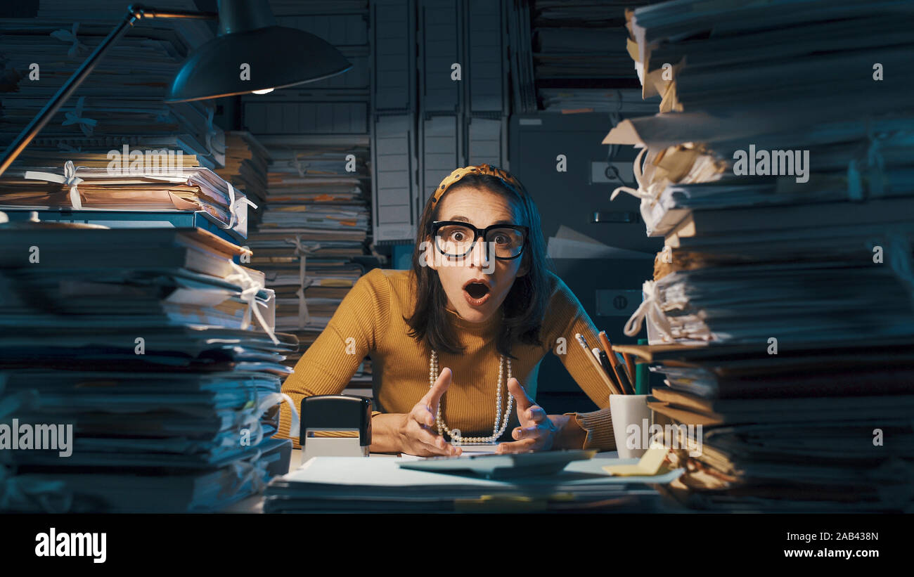 Shocked upset woman sitting at office desk and staring at camera, she ...