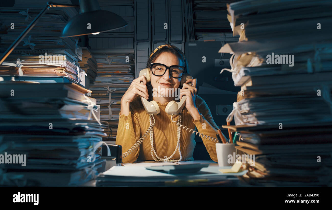 Smart businesswoman answering two phone calls at the same time, she is ...