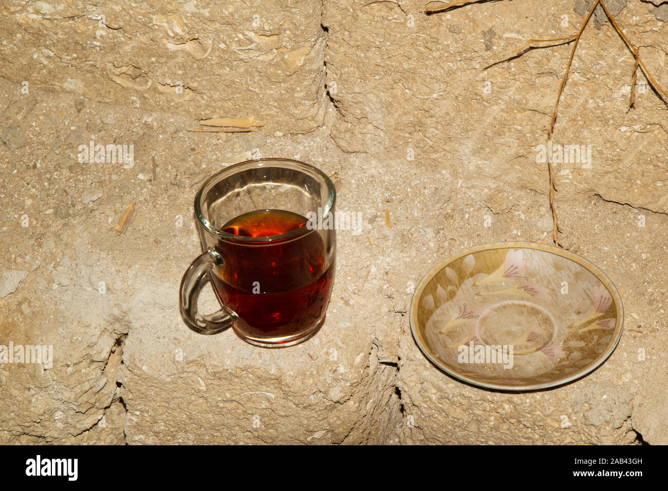 Black in gass cup and little plate on the ground Stock Photo - Alamy