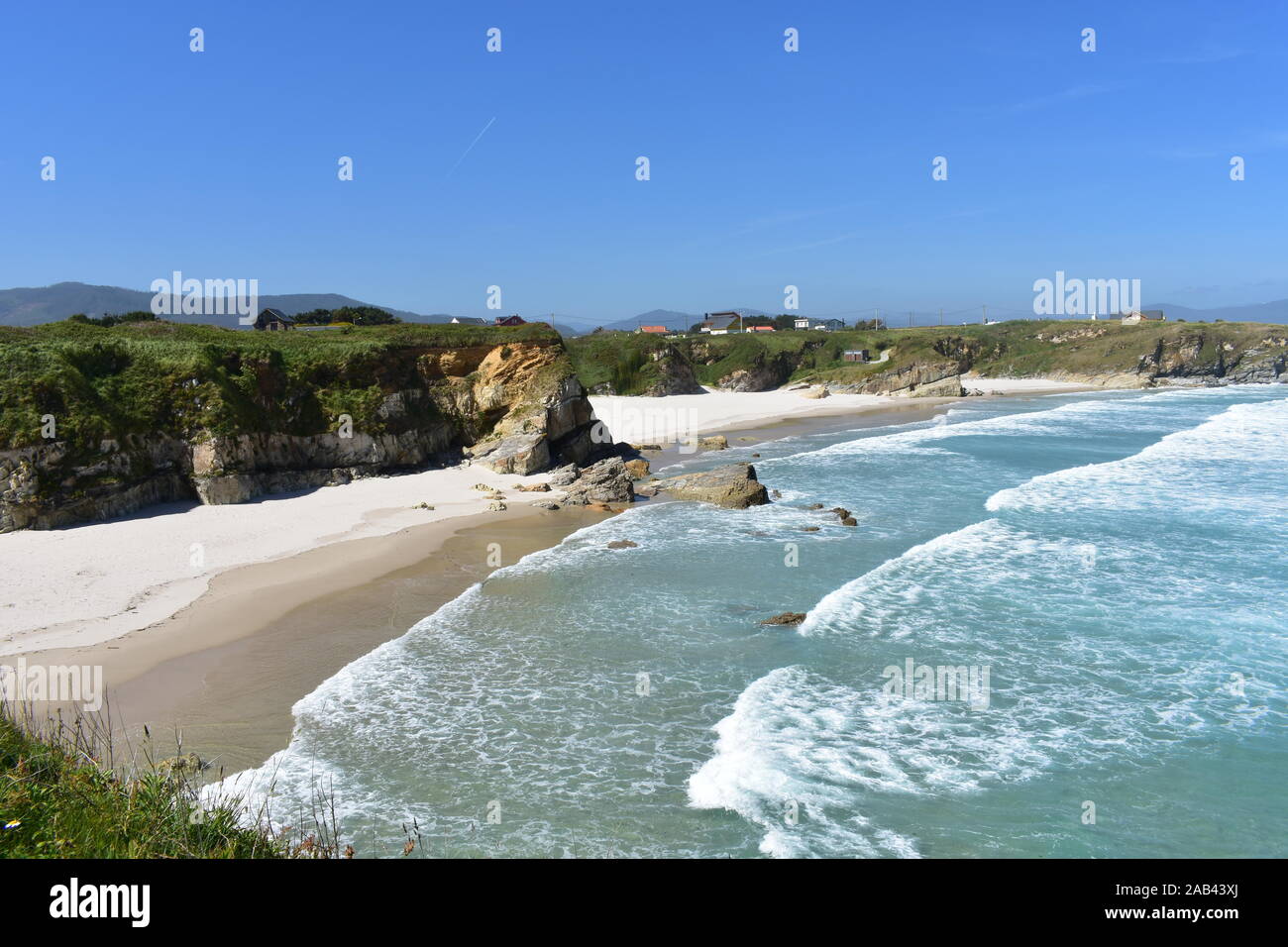 Beach with cliff, white sand and waves. Viveiro, Lugo Province, Spain ...