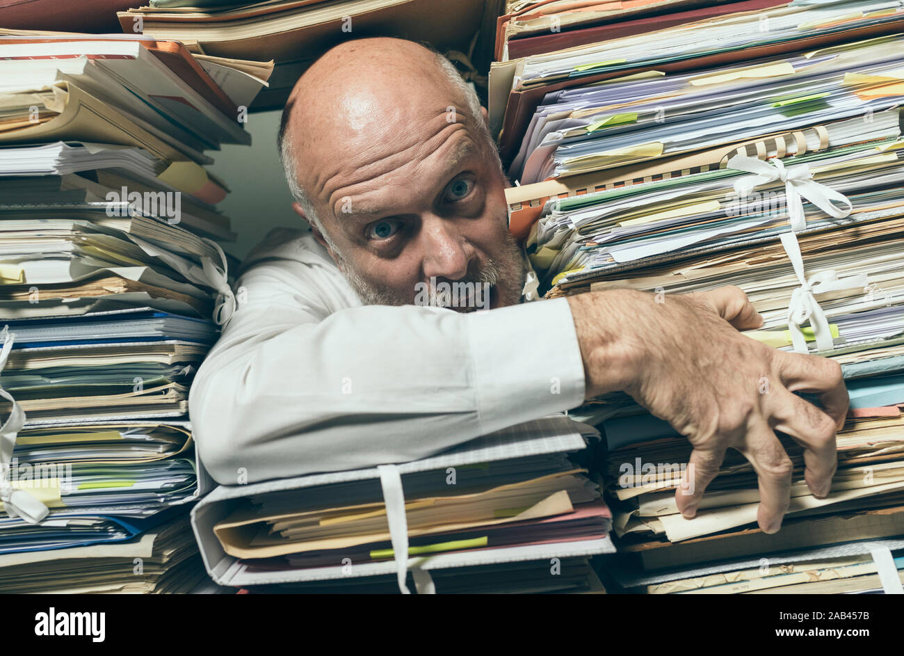 Panicked stressed businessman overloaded with paperwork, he is asking ...