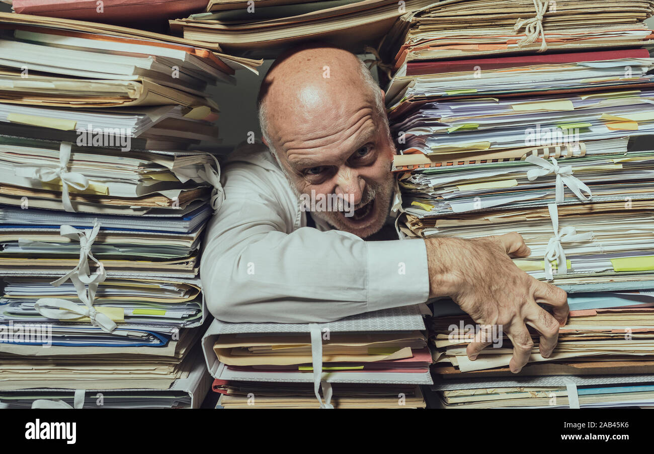 Panicked stressed businessman overloaded with paperwork, he is asking ...