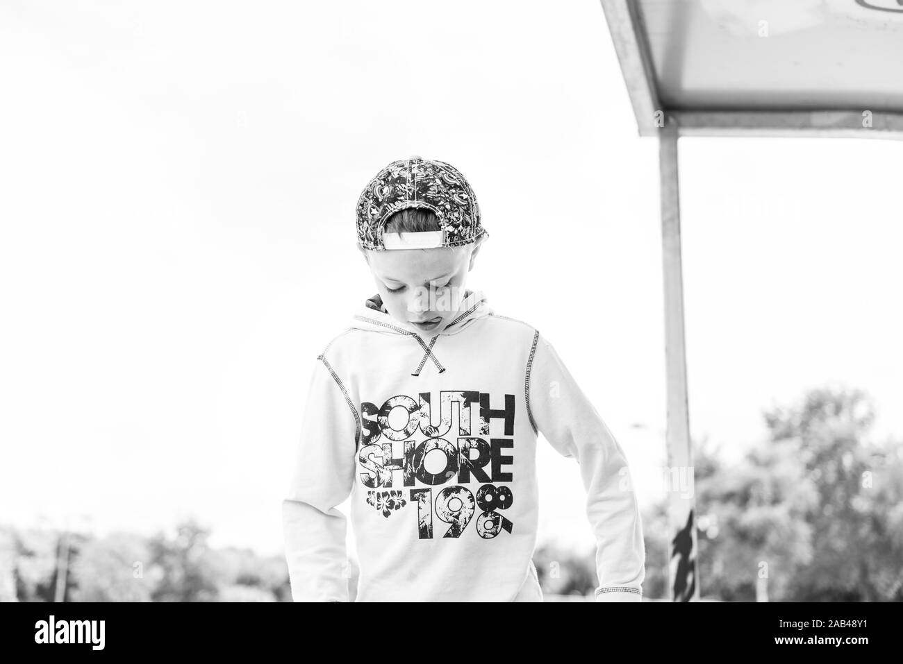 A cute little boy with ADHD, autism, Asperger syndrome riding around ...