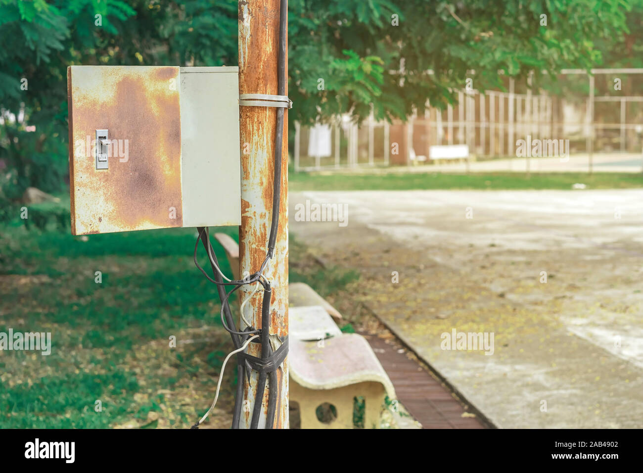 Old rusty electrical power control box on rusted electric pole in the ...