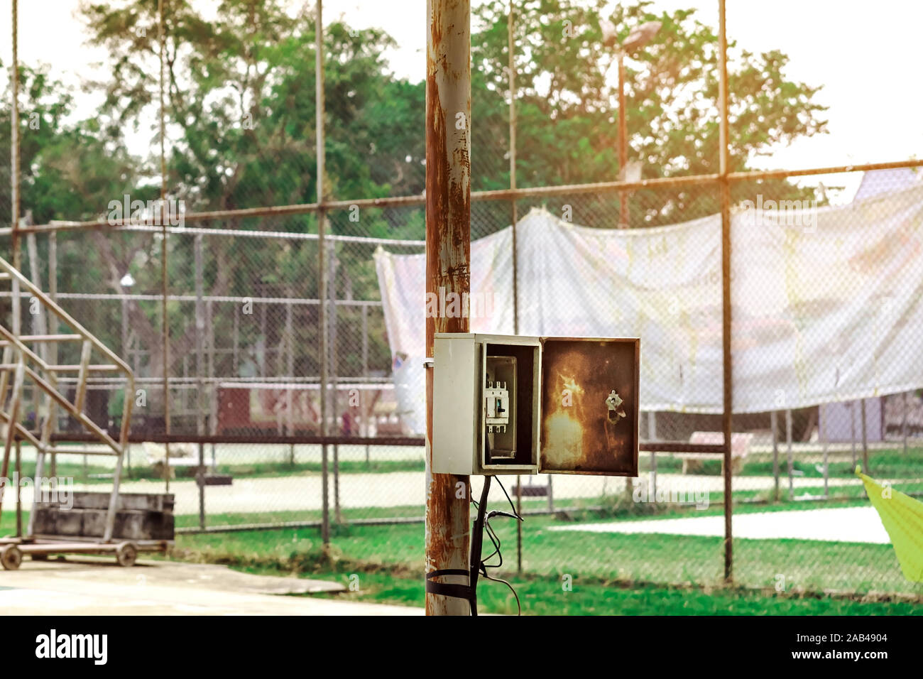 Old rusty electrical power control box on rusted electric pole in the ...