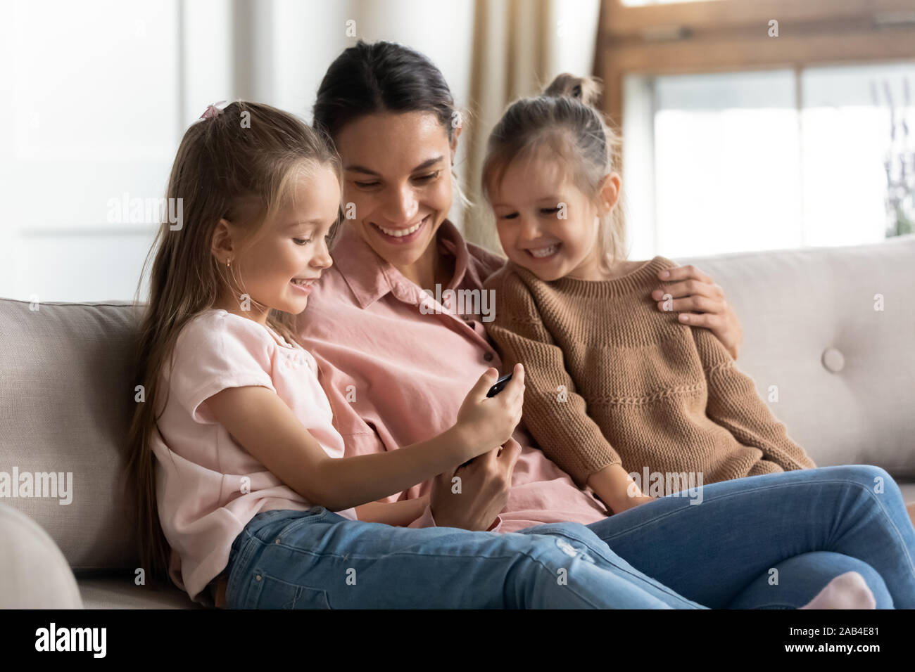Mom using phone with kids hi-res stock photography and images - Alamy
