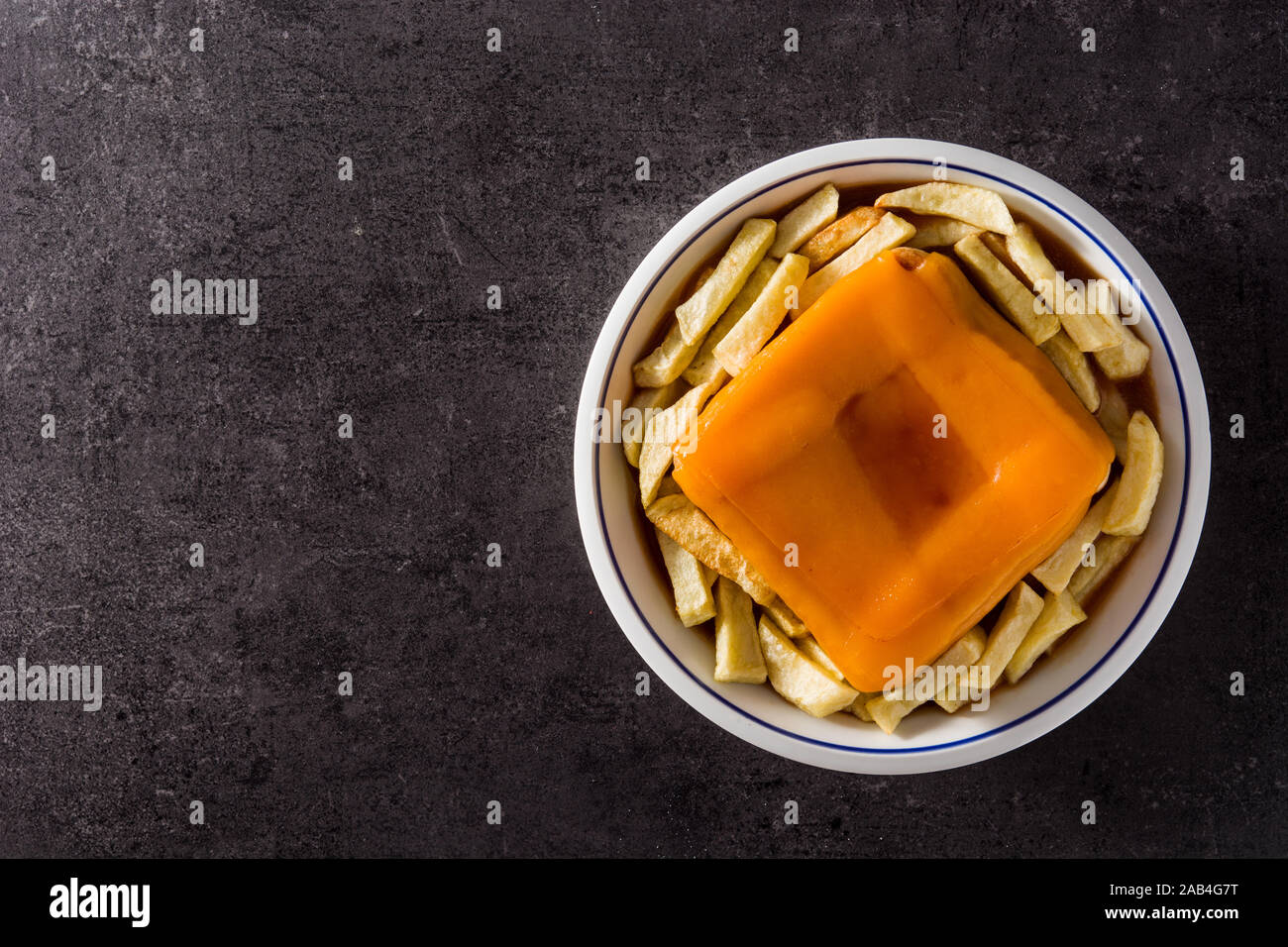Typical Portuguese francesinha sandwich with french fries on black ...