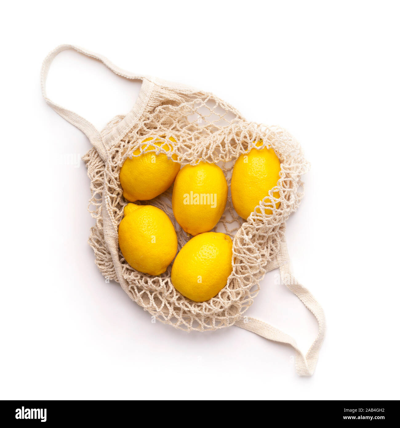 Fresh lemons inside reusable net bag isolated on white Stock Photo - Alamy
