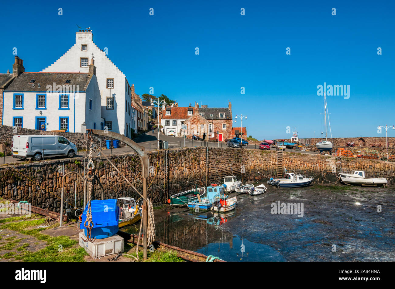 Boats in the harbour of the picturesque seaside village of Crail in the ...