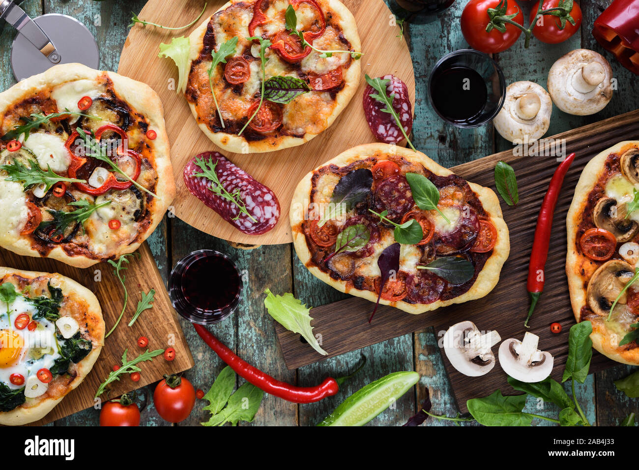 Pizza and wine party. Homemade rustic pizzas and raw ingredients served ...