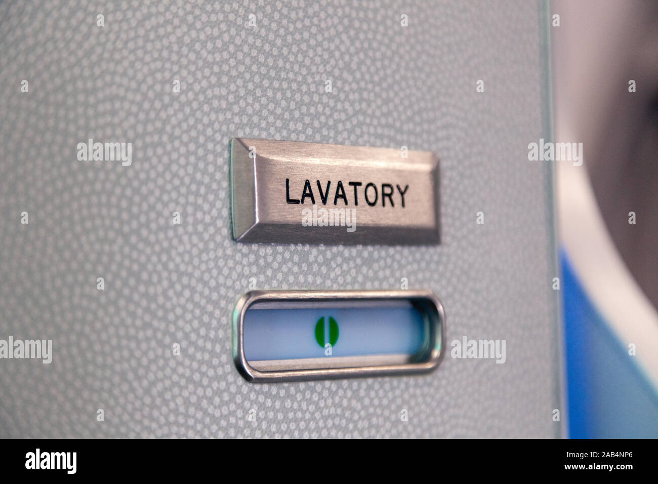 Vacant green sign, vacant symbol on an airplane lavatory door. Raised ...