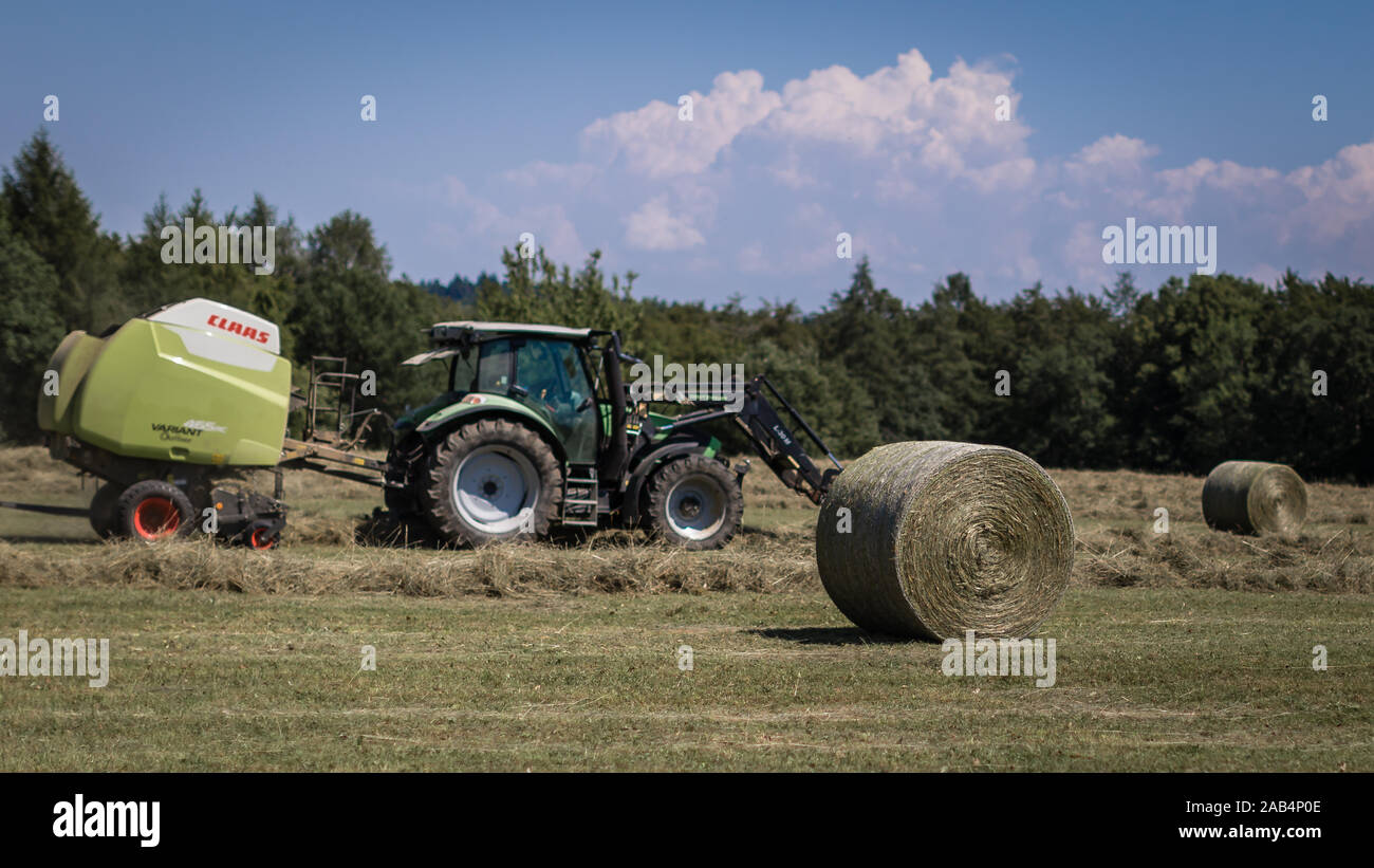 Harvesting hay in the height of summer in Germany Stock Photo - Alamy