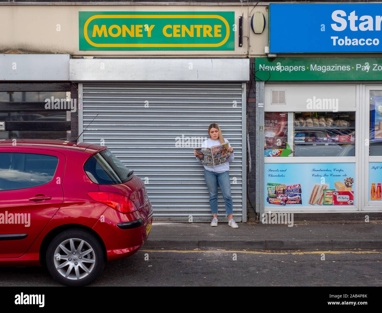 Young woman reading tabloid newspaper hi-res stock photography and ...
