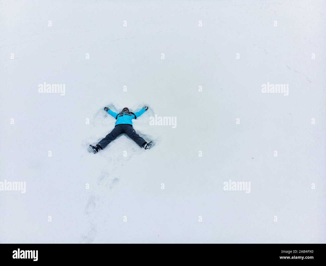 overhead view woman making snow angel Stock Photo - Alamy