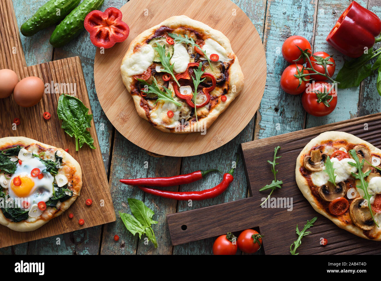 Pizza party flatlay. Freshly backed homemade rustic pizzas with eggs ...