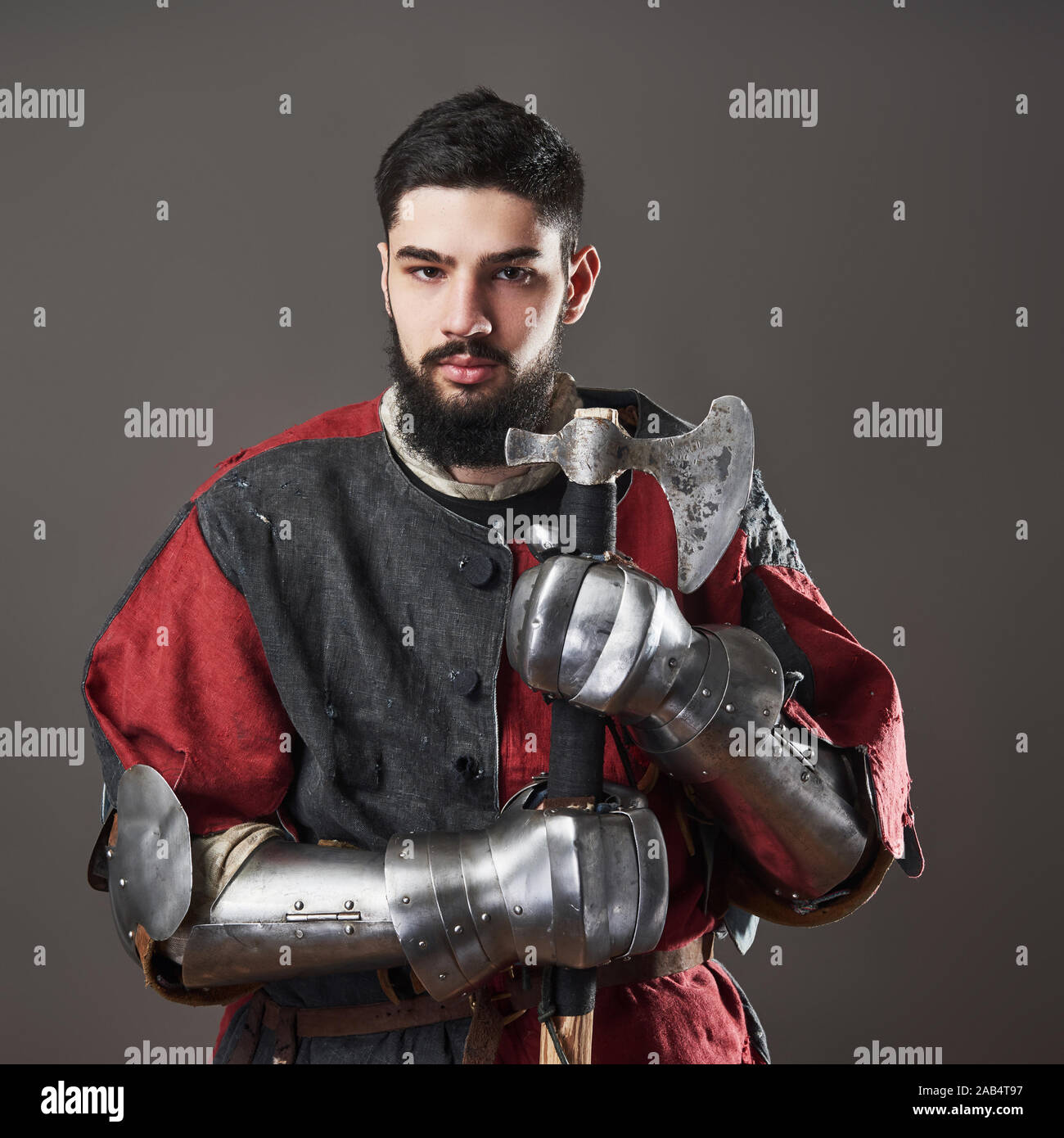 Medieval knight on grey background. Portrait of brutal dirty face ...