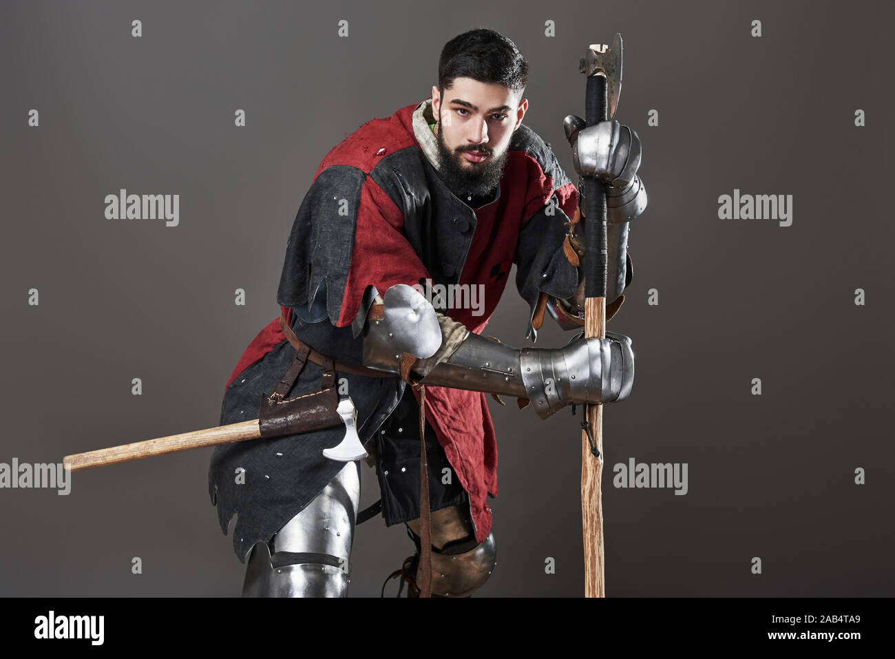 Medieval knight on grey background. Portrait of brutal dirty face ...