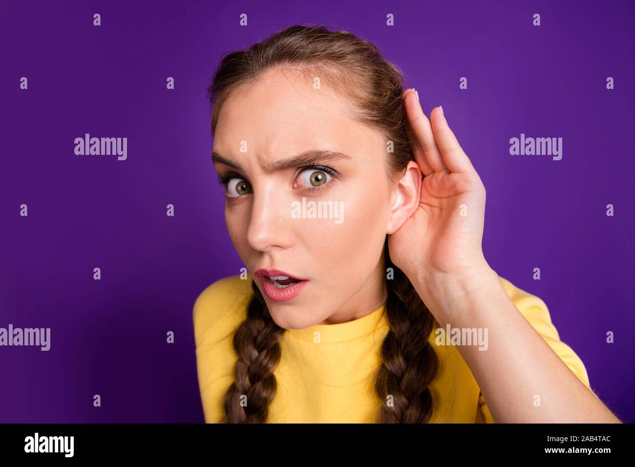 Closeup photo of funny lady long braids holding arm near ear listening ...