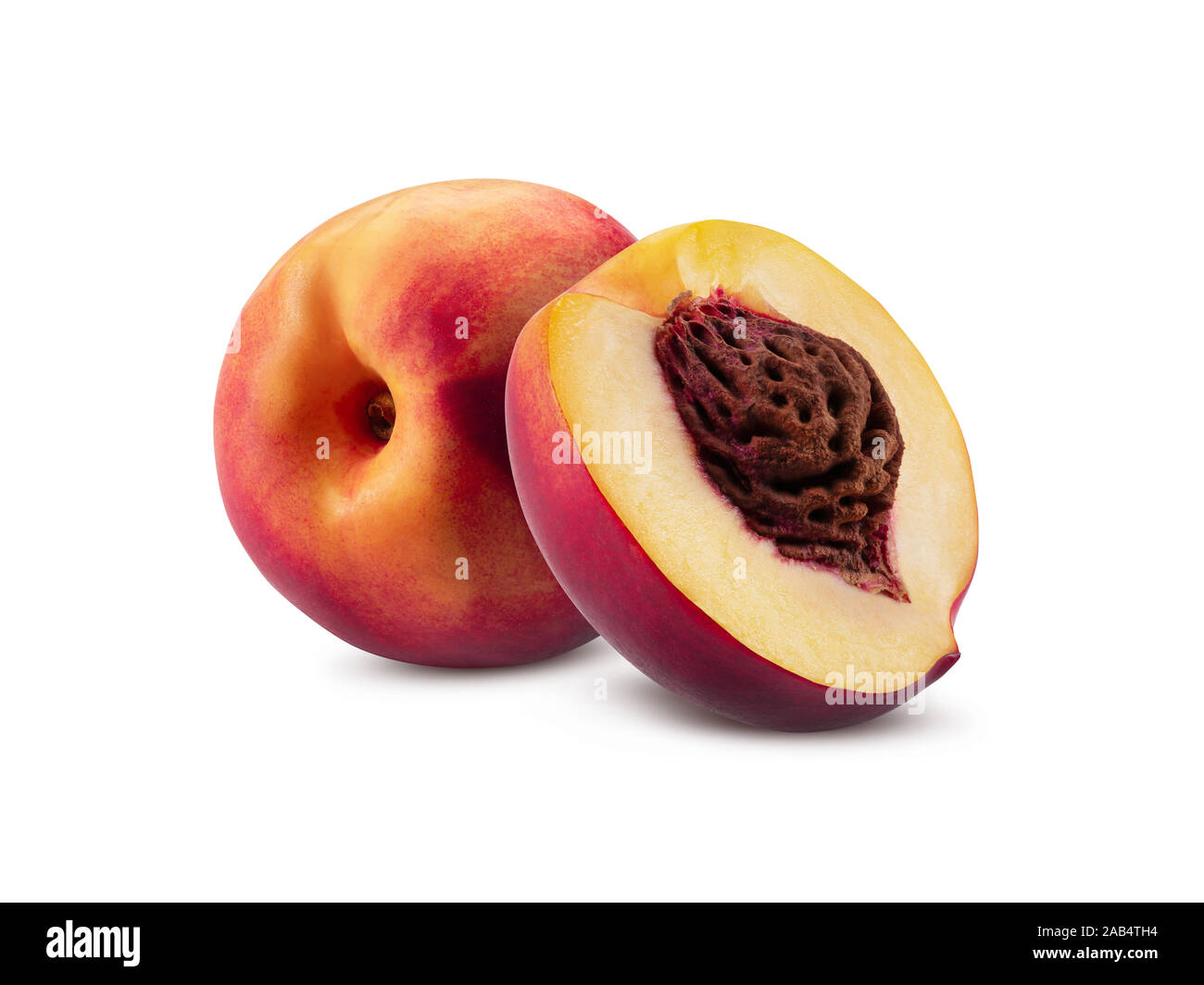 Smooth-skinned whole nectarine and one half with kernel isolated on ...