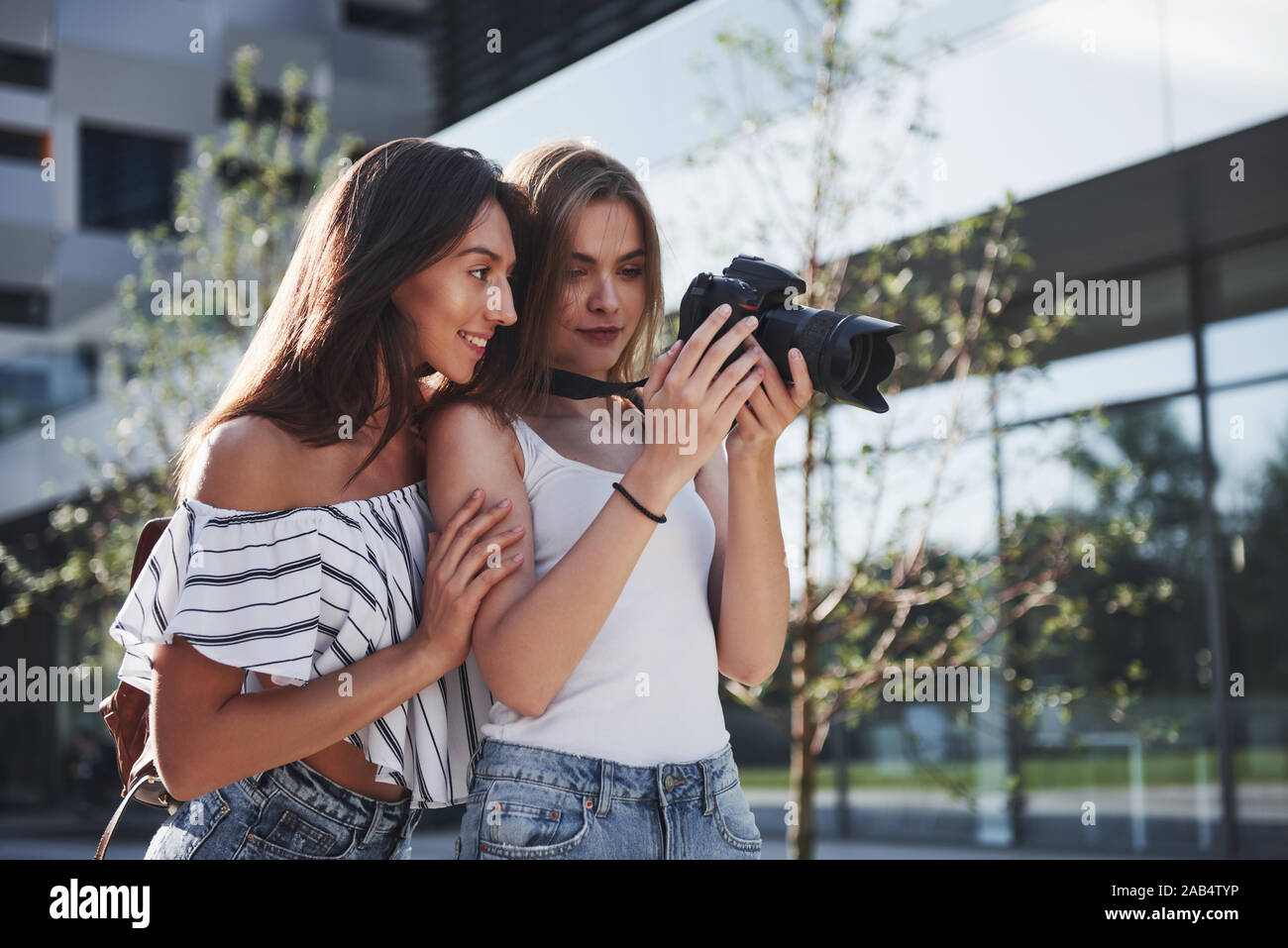Two pretty pretty friends of the girl with the camera take photos ...