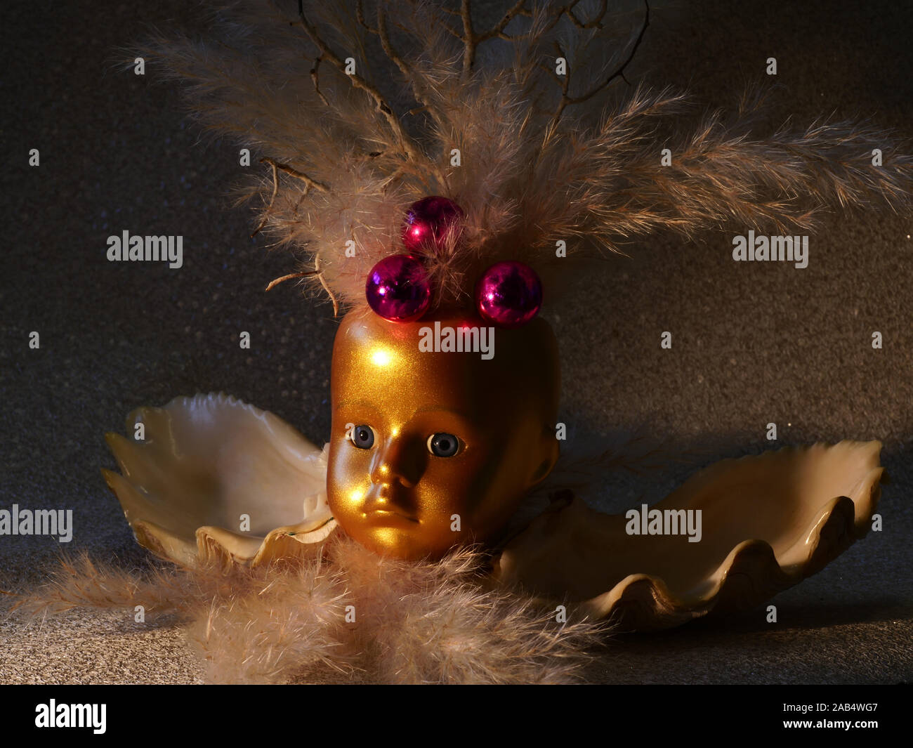 Doll head, gold face goddess with clam shell wings Stock Photo - Alamy