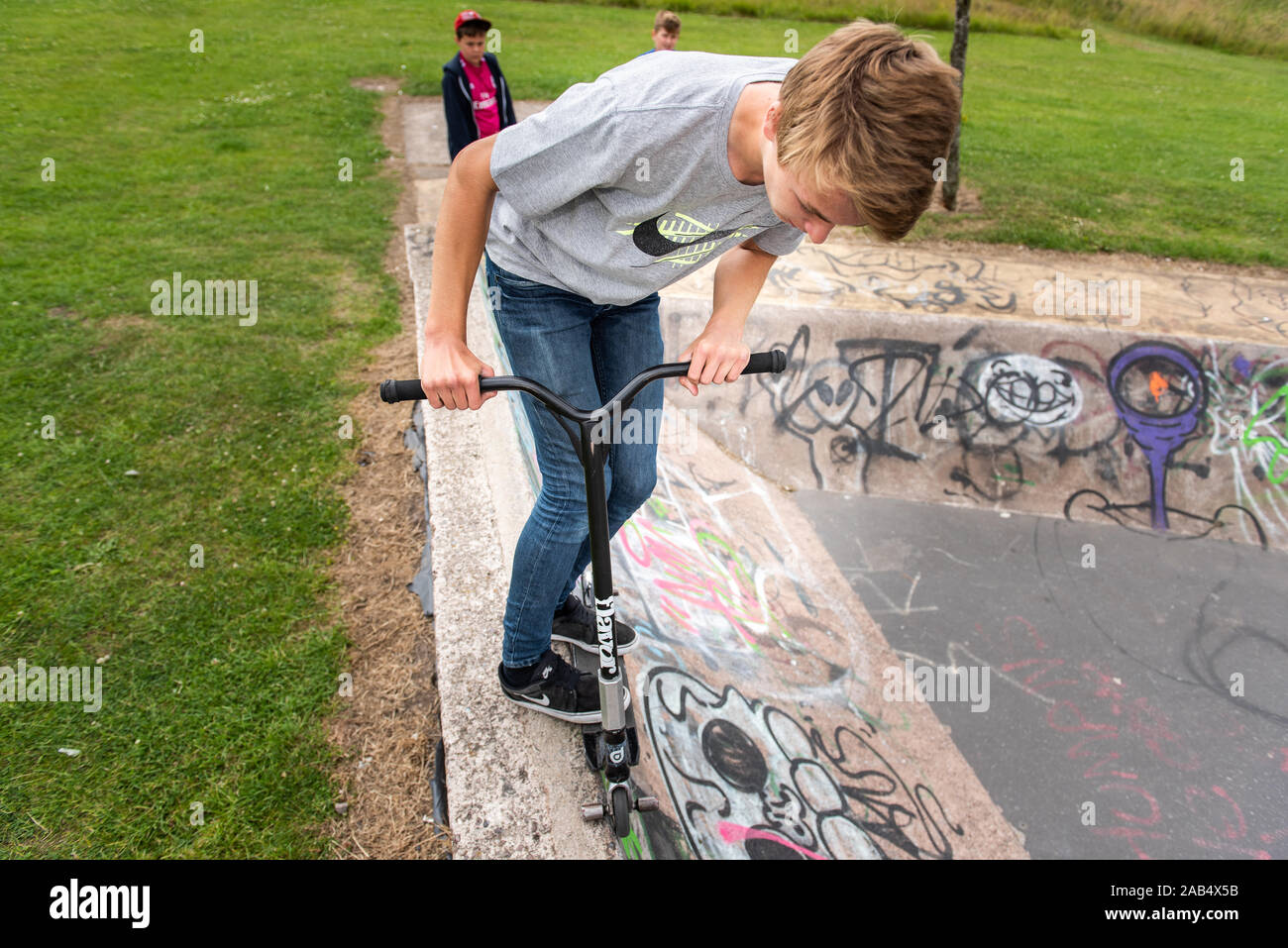 Professional scooter rider Josh Glass rides around the local skate park ...