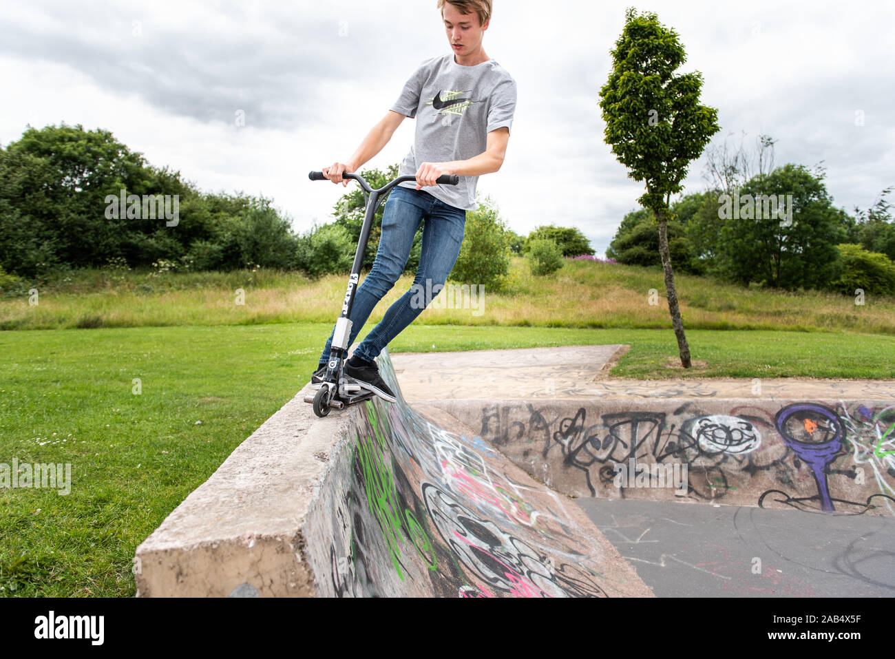 Professional scooter rider Josh Glass rides around the local skate park ...
