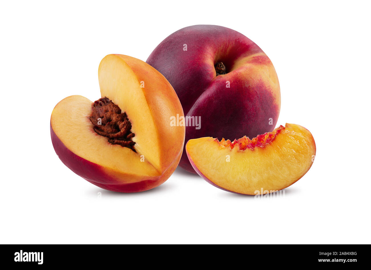 Whole nectarine, one unpitted slice and one cutted part with kernel ...