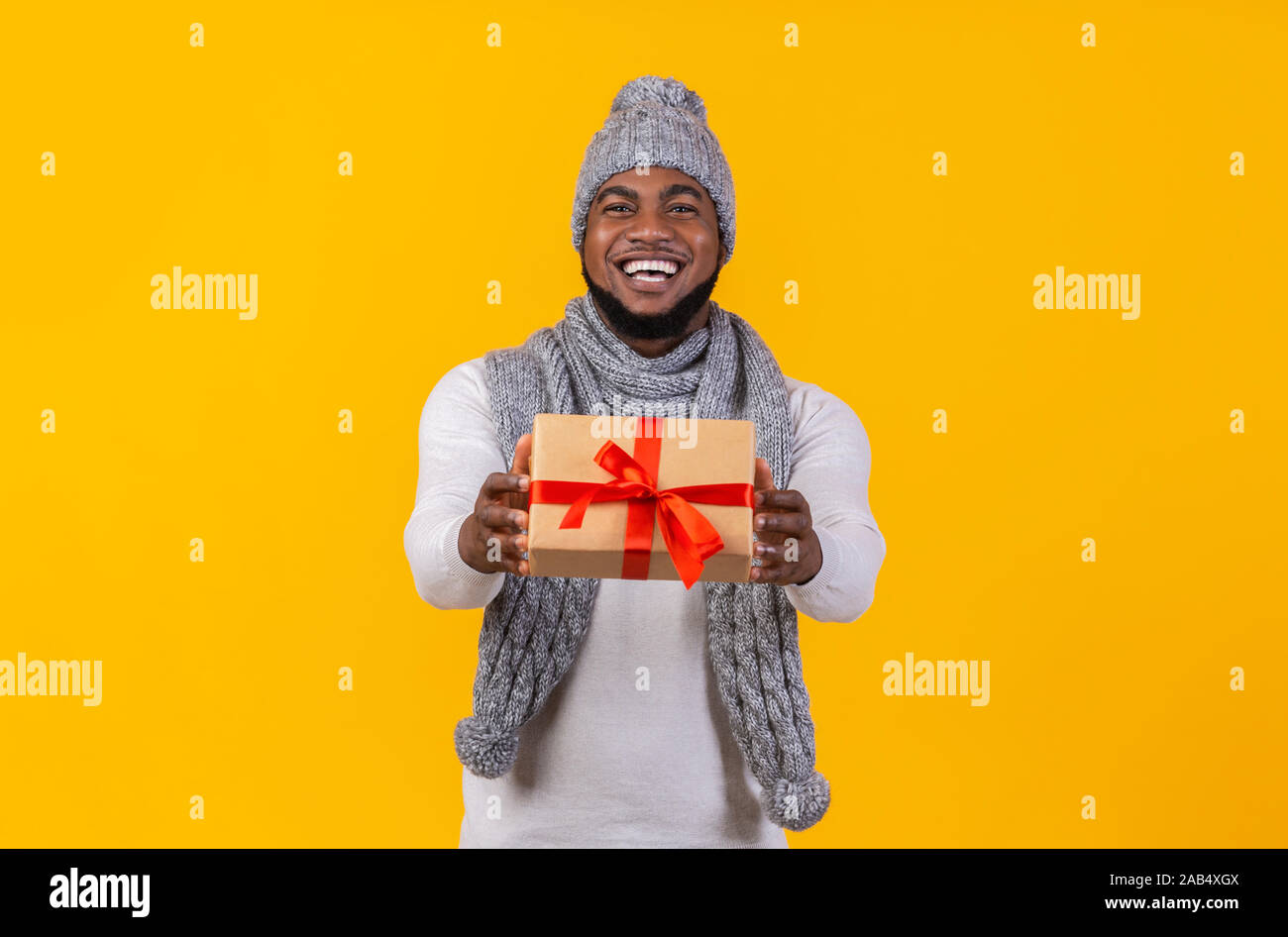 Handsome guy giving christmas present hi-res stock photography and ...